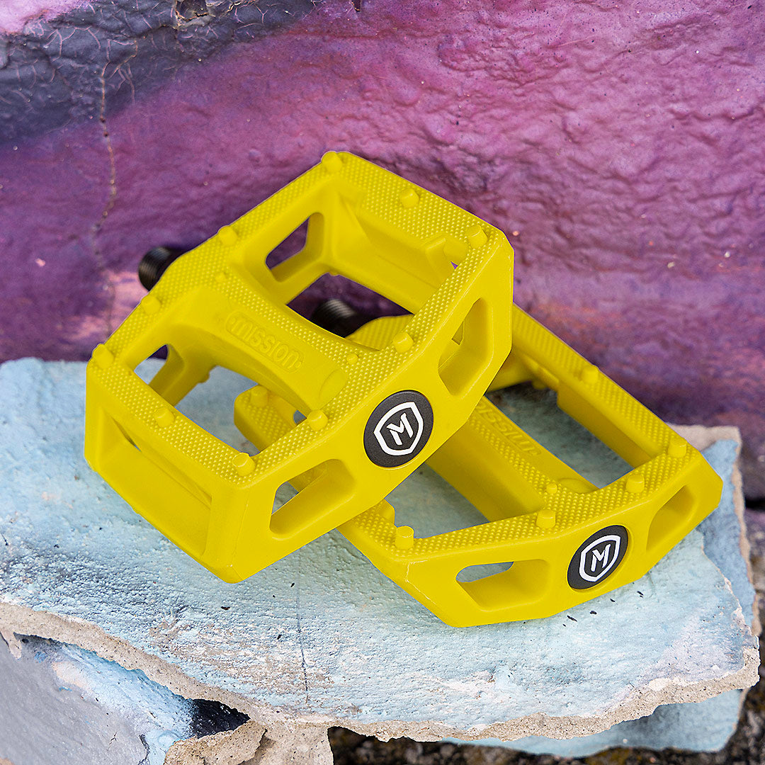 Bright yellow Mission BMX pedals.